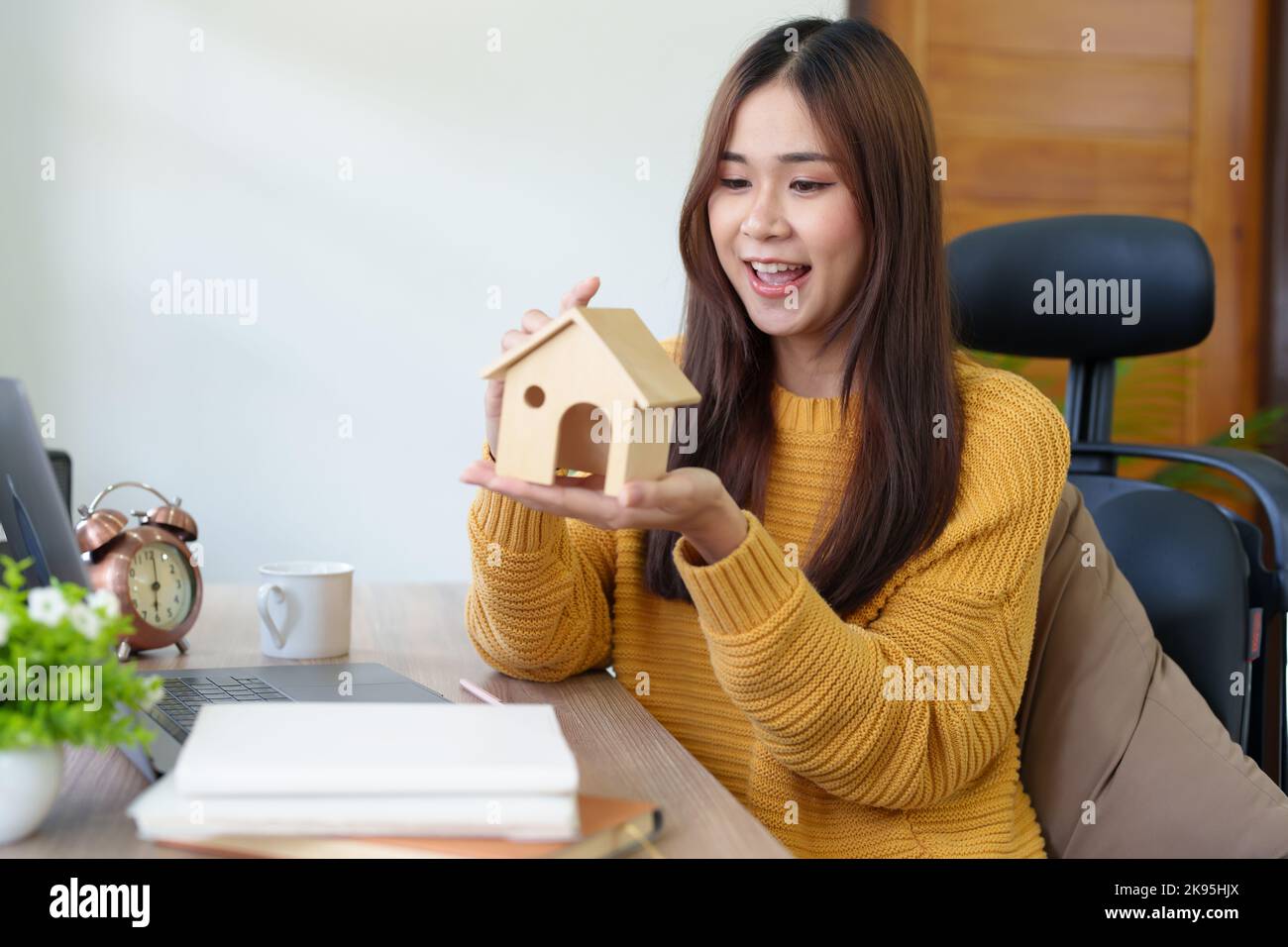 A woman showing joy after making a successful purchase of a house with a bank Stock Photo - Alamy