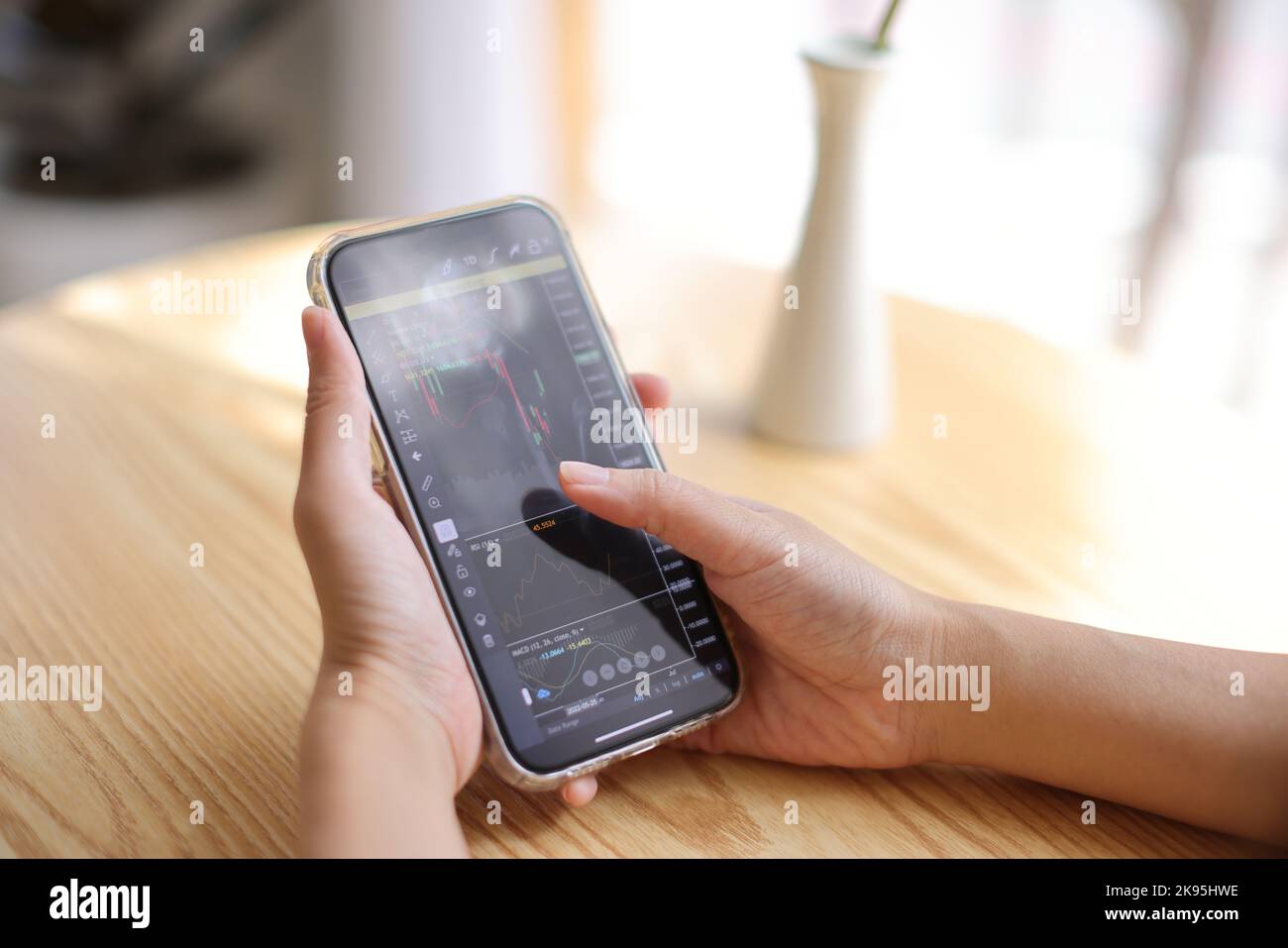 Woman hand using a smartphone for Stock exchange trading online in the ...
