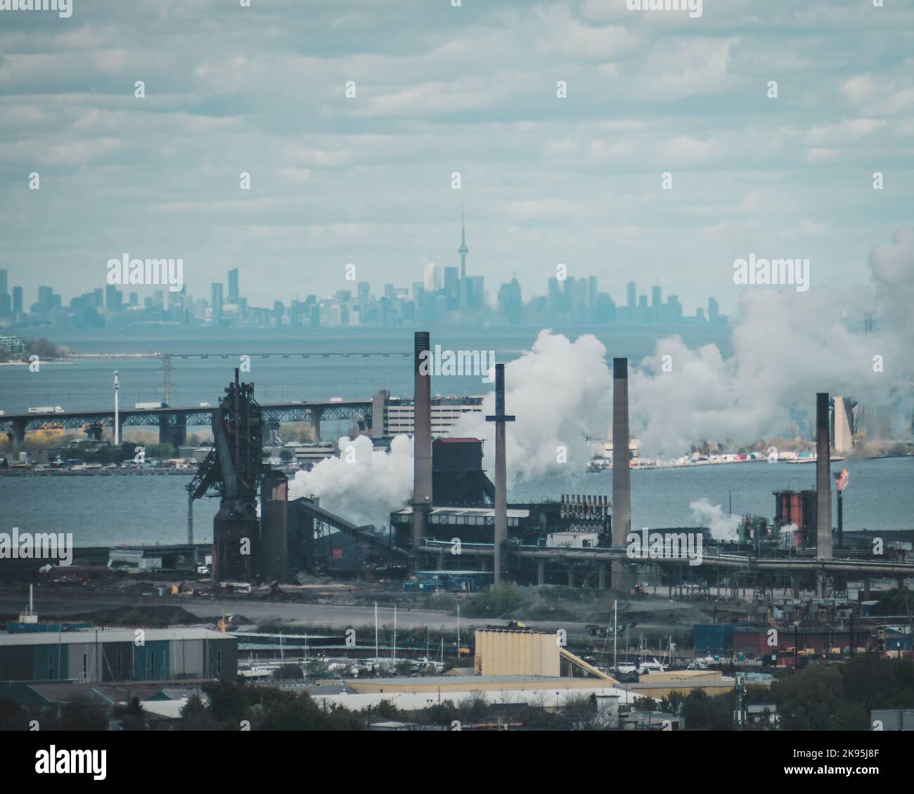 The smoke coming out from Hamilton factories with the Skyway bridge and ...
