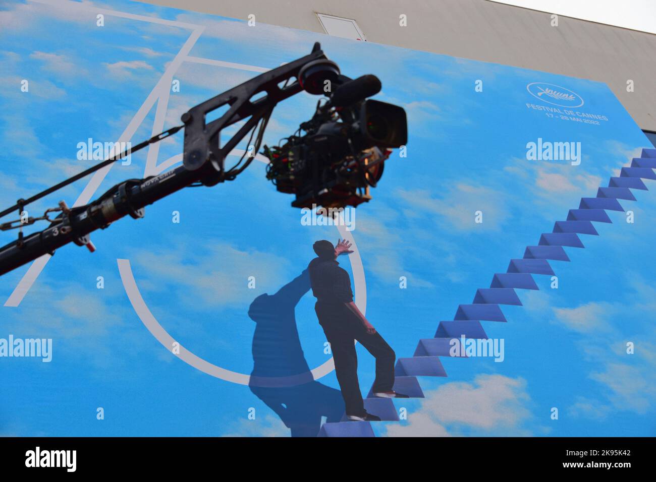 Camera in front of the official poster of the 75th Cannes Film Festival ...