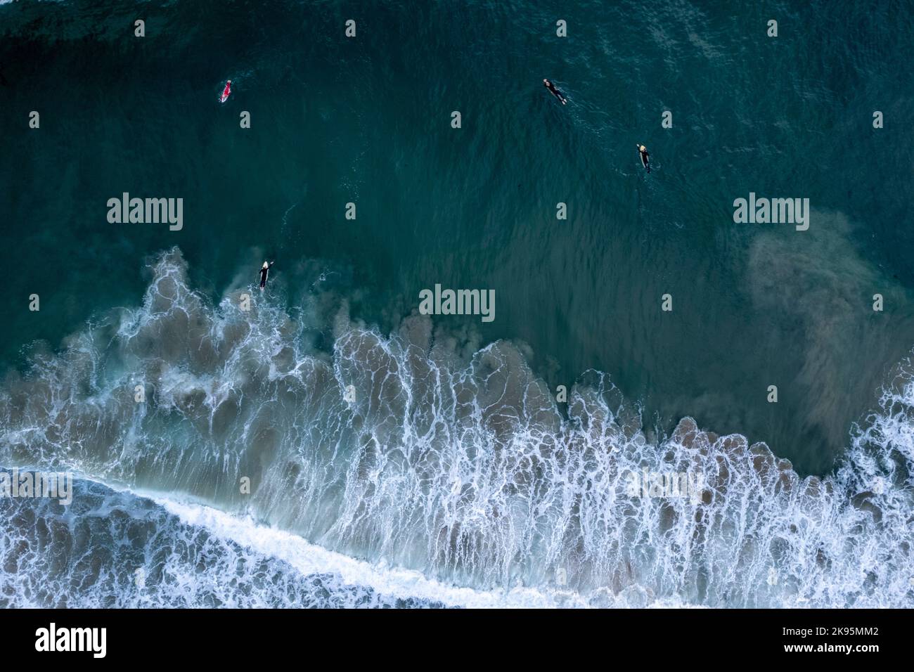 An aerial view of sandy beach by the tide tranquil sea waves water ...