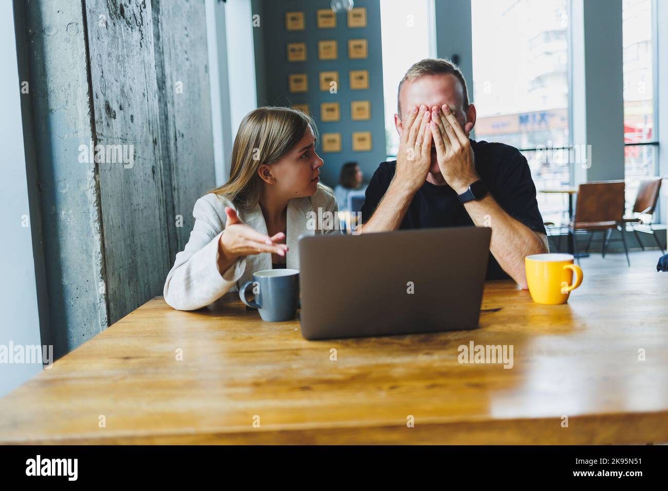 Young colleagues managers are sitting at the table and laughing ...