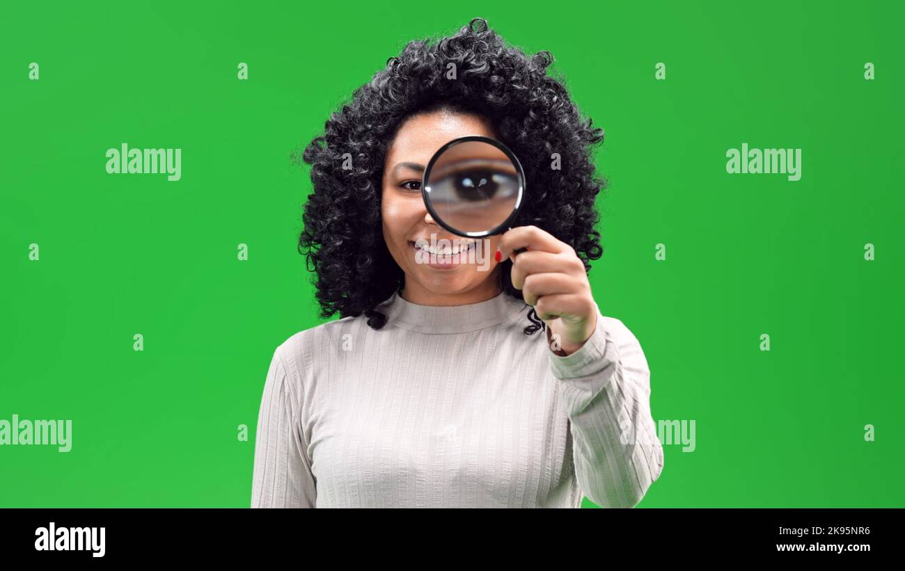 An isolated African American female on a green screen smiling and ...