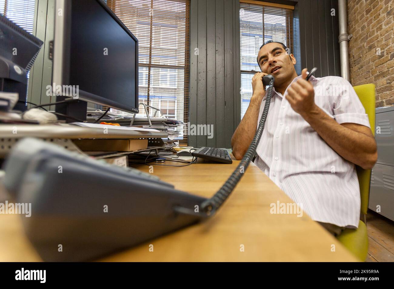 The Media Agency: Phone Conversation. An office manager at his desk ...