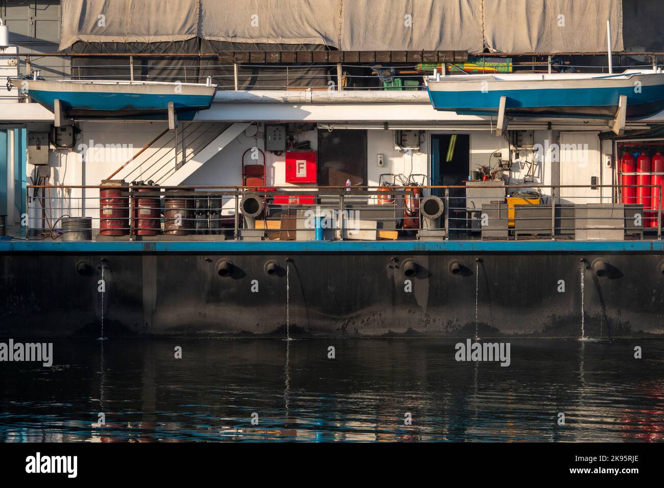 A detail of a Nile cruise boat from the aft end moored and reflected in ...