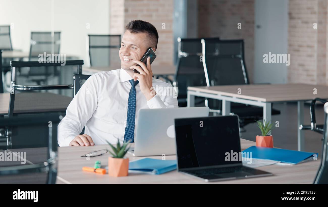 A male businessman having a call at the office Stock Photo - Alamy
