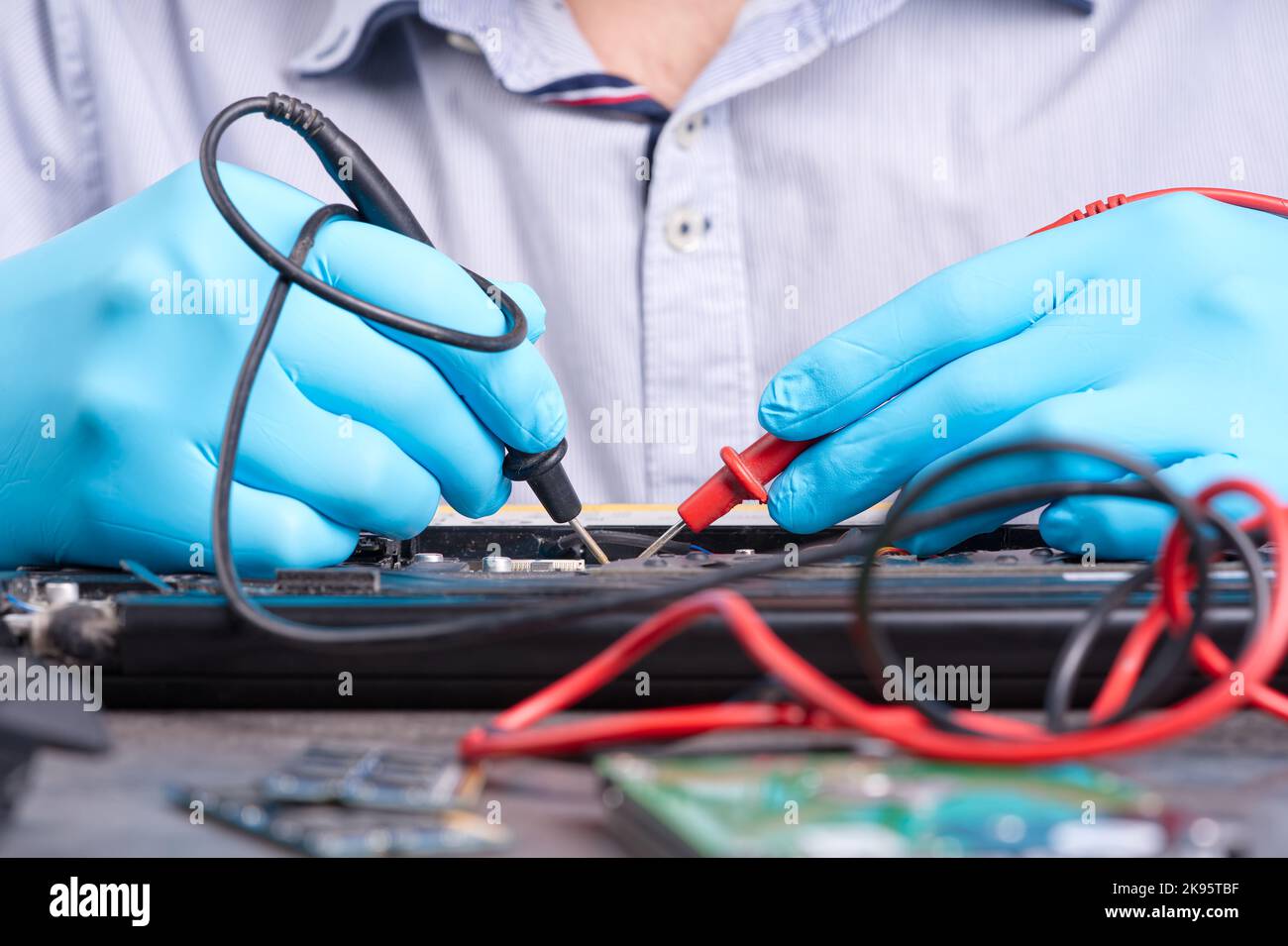 Hands fixing motherboard of pc or laptop notebook close up in service ...