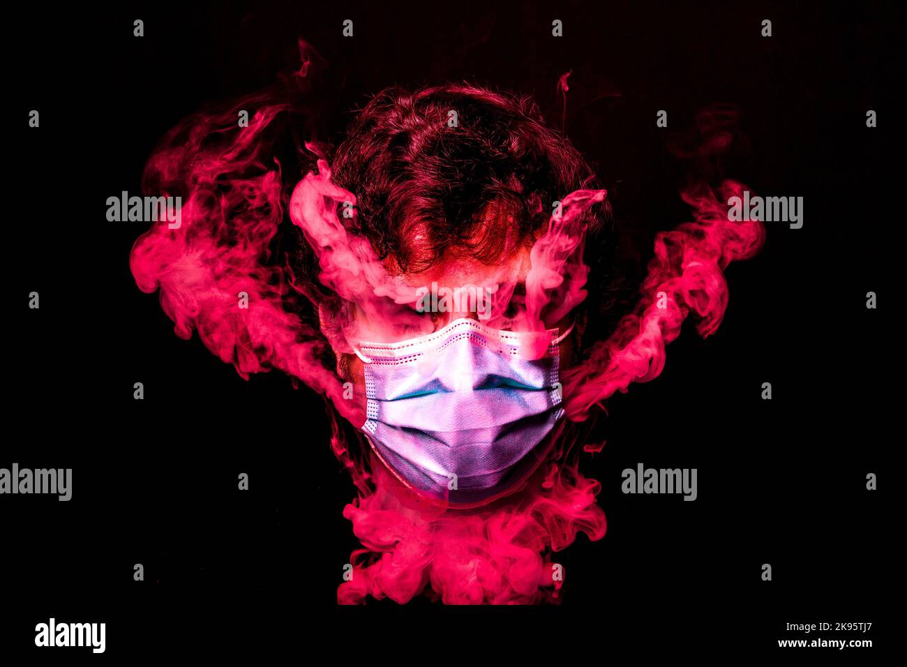 A man's face in red smoke wearing mask on black background Stock Photo ...
