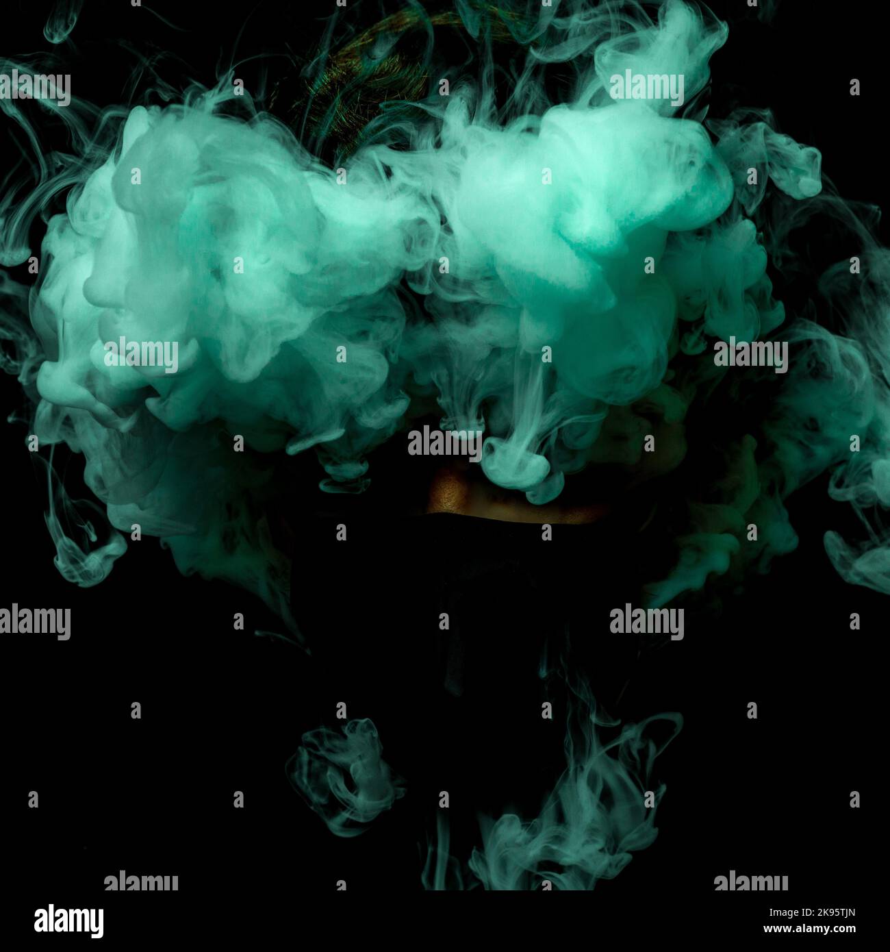 A man's face in green smoke wearing mask on black background Stock ...
