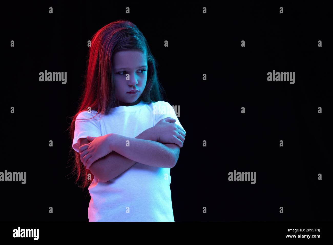 Resentment. Sad little girl, kid in white t-shirt expressing emotions ...