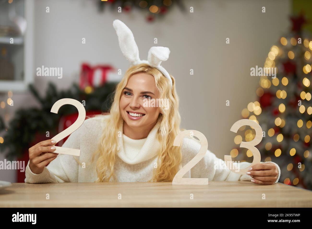Front view of blonde woman wearing rabbit ears having photoshoot ...