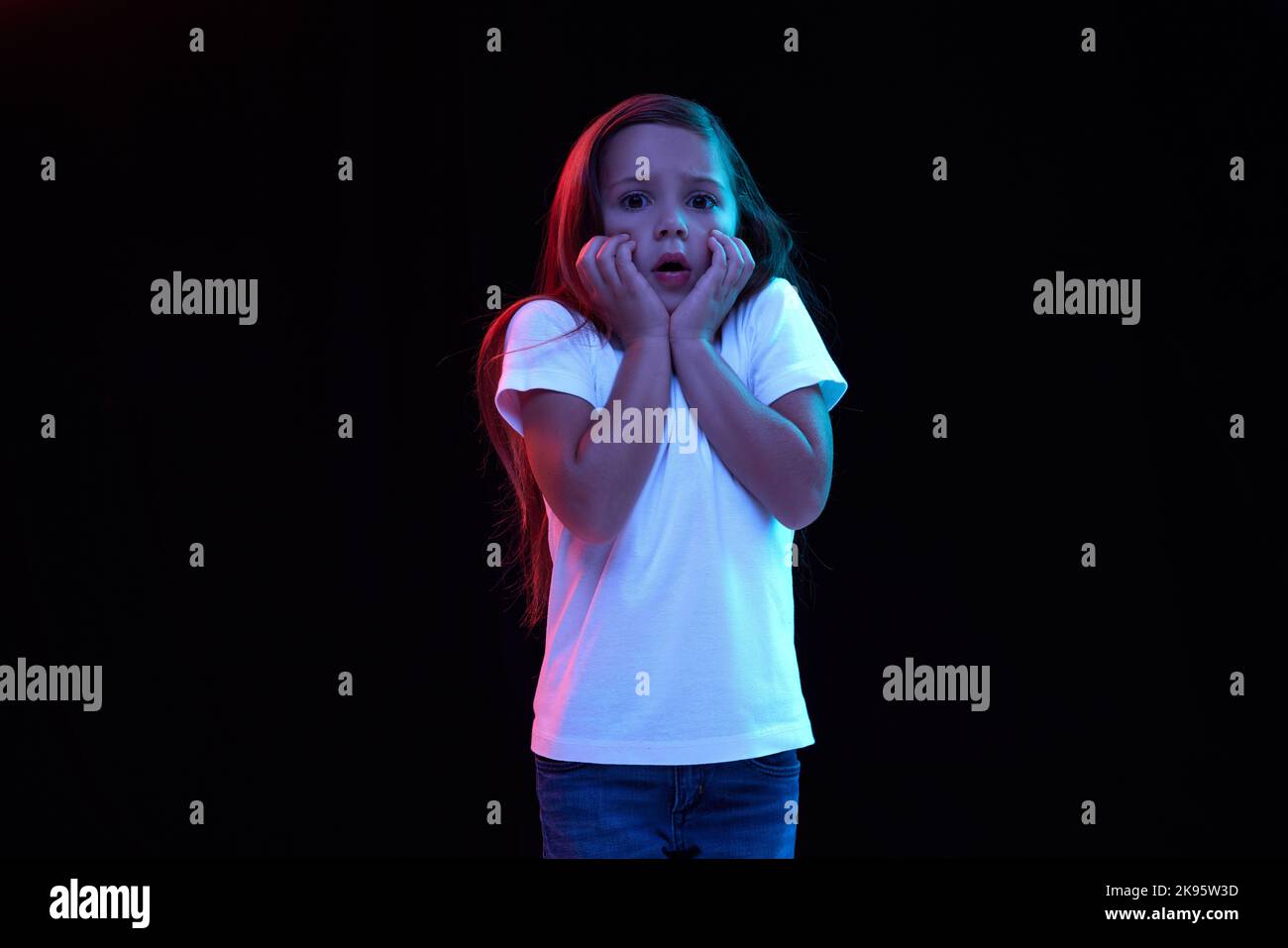 Scared little girl, kid in white t-shirt expressing emotions isolated ...