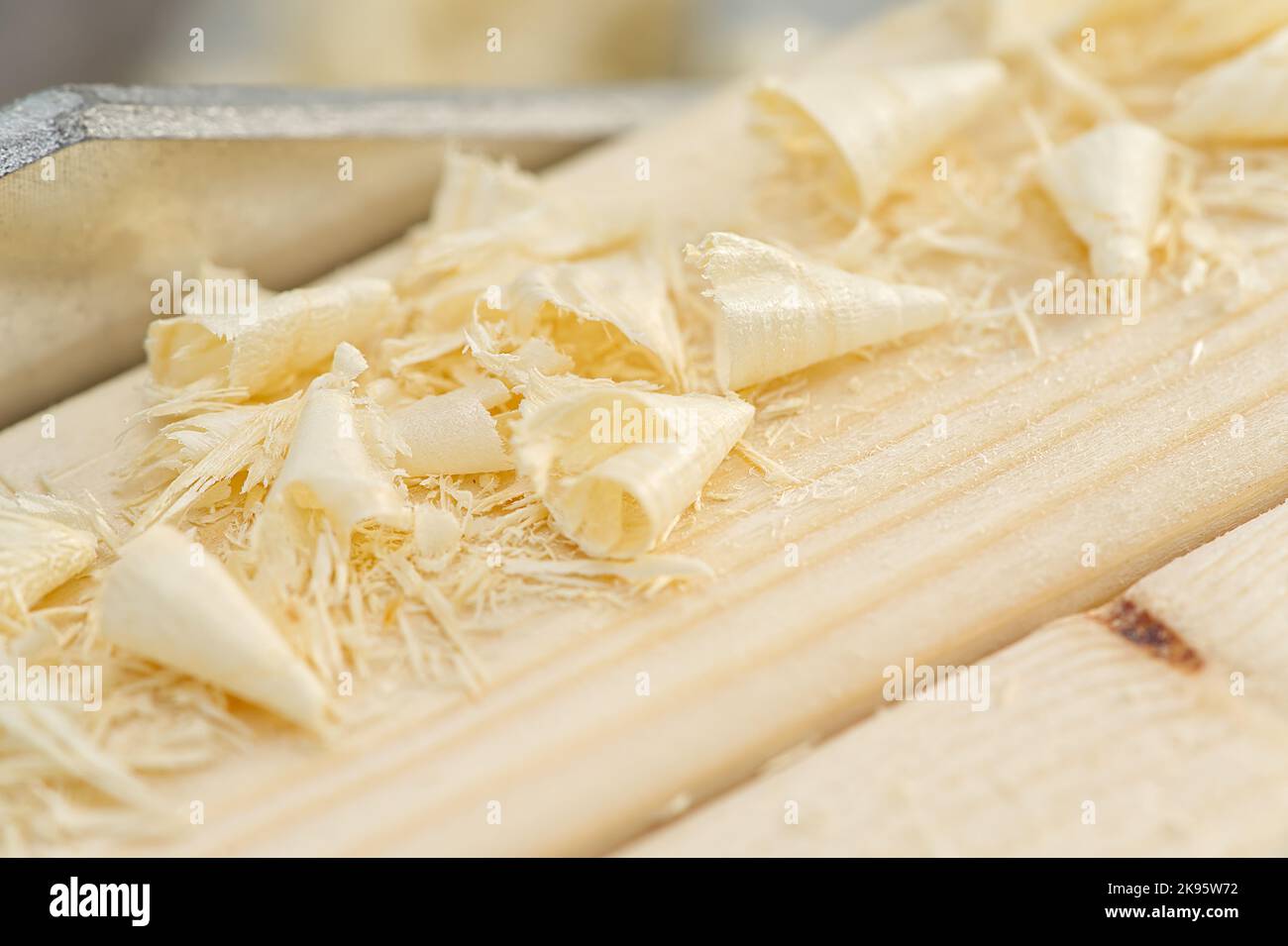 Carpenter drilling holes in the wood beam. wooden frame domestic house ...
