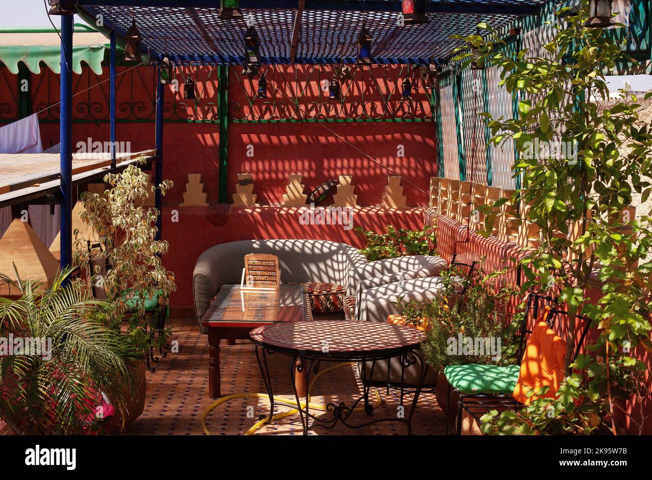 A cafe table and chairs with decorations and green plants Stock Photo ...