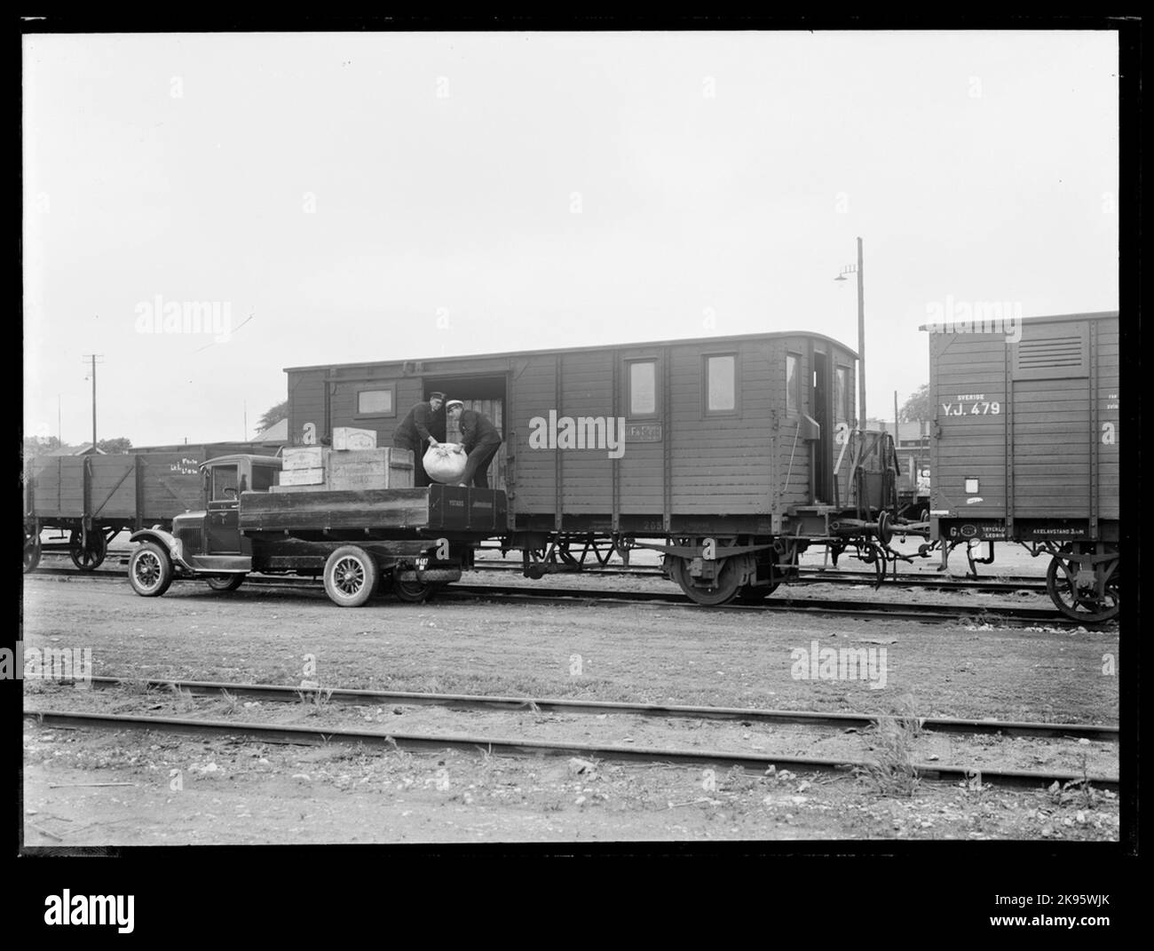 Loading to truck from freight wagon. Malmö - Ystads Railway, MyJ f3b 205. Truck belonging to ...