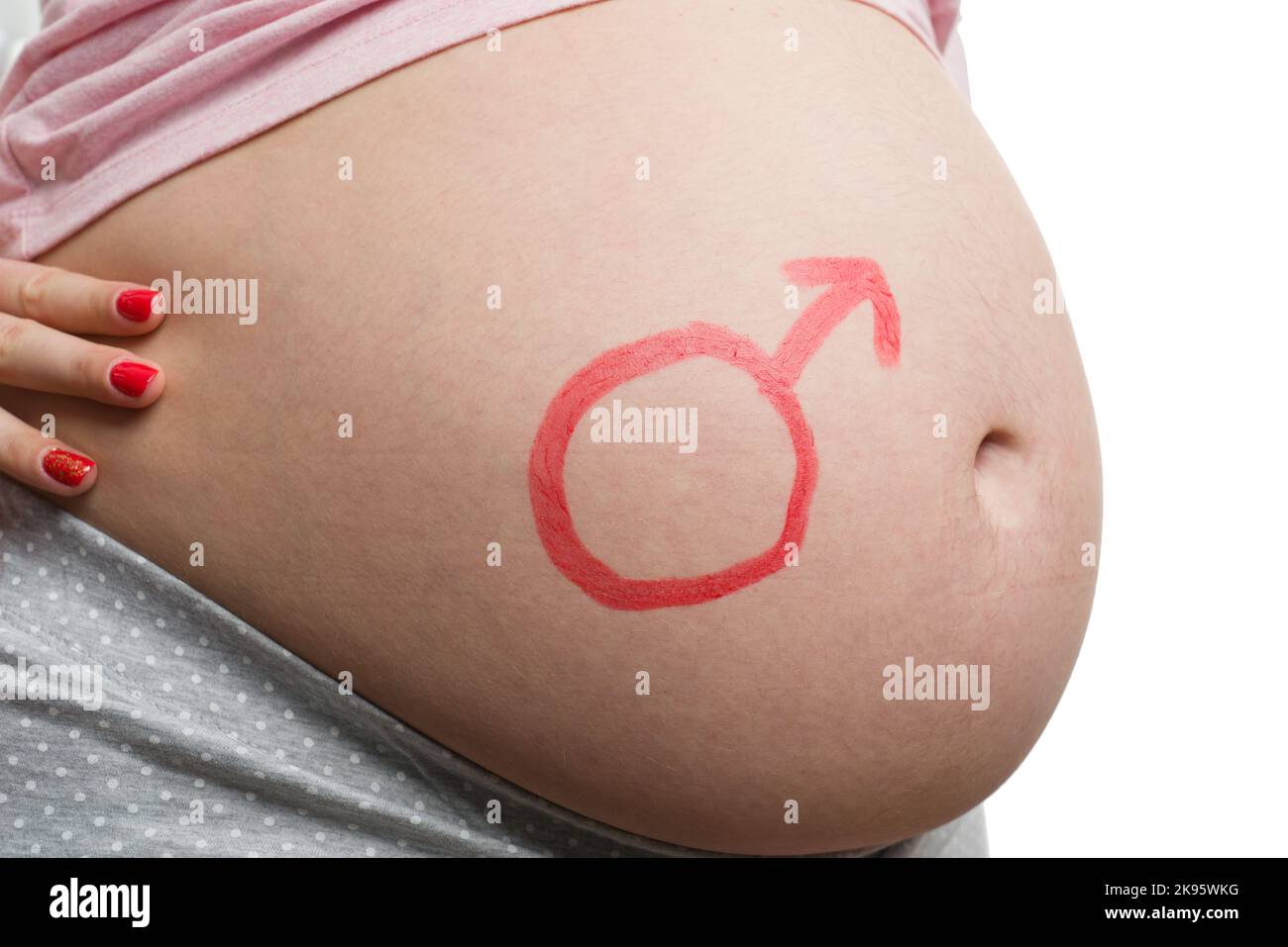Close-up of pregnant tummy with Mars symbol drawing as baby boy concept ...