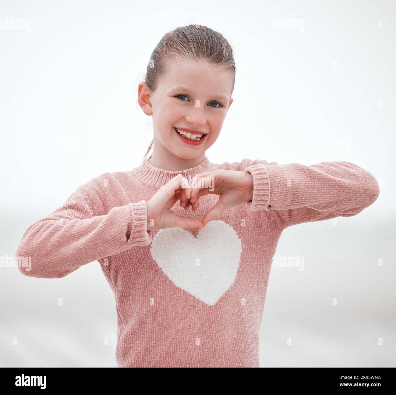 Happy, teenager girl and hands for heart gesture, sign or symbol with ...