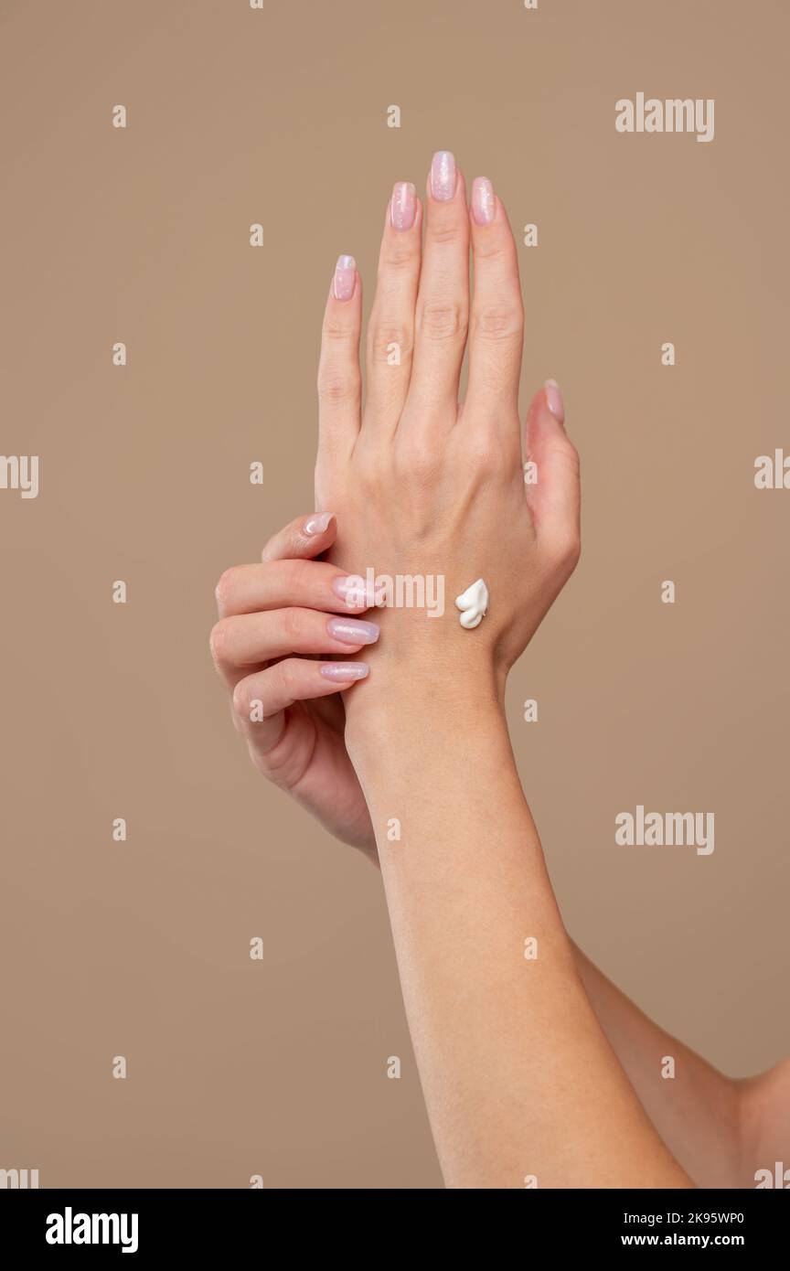 Hand applying cream hi-res stock photography and images - Alamy