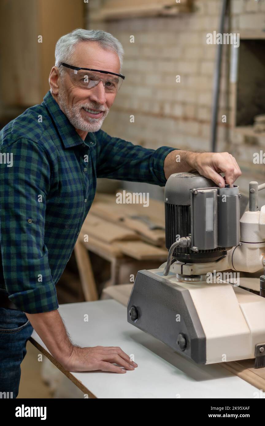 Craft person working with wood in a workshop Stock Photo - Alamy