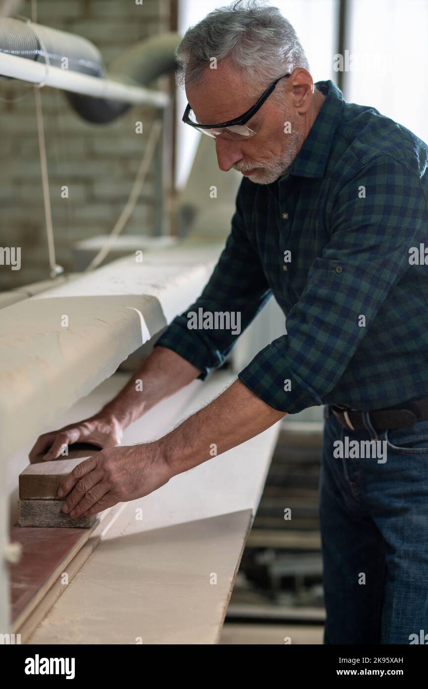 Craft person working with wood in a workshop Stock Photo - Alamy