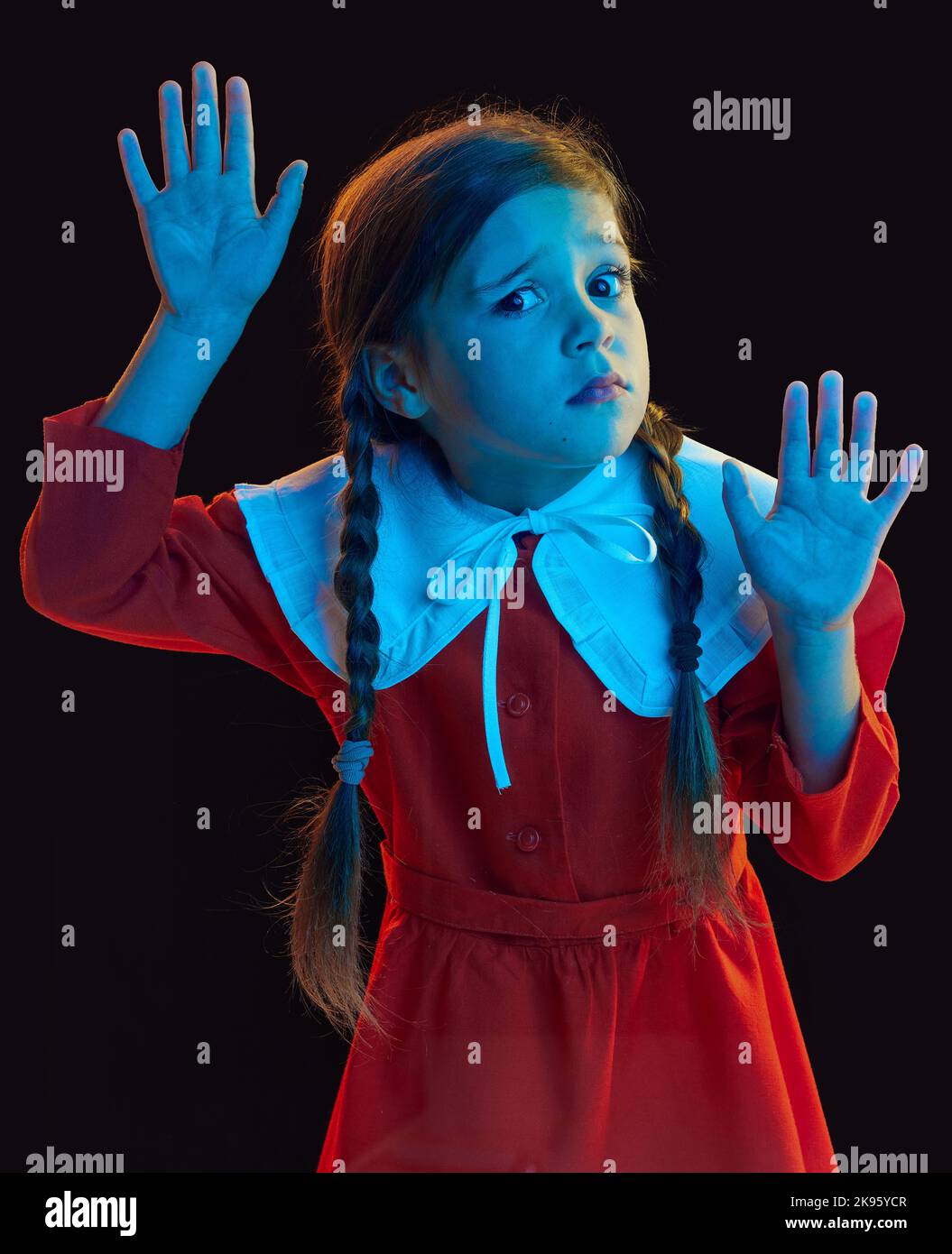 Portrait of beautiful cute little girl with pigtails wearing red ...