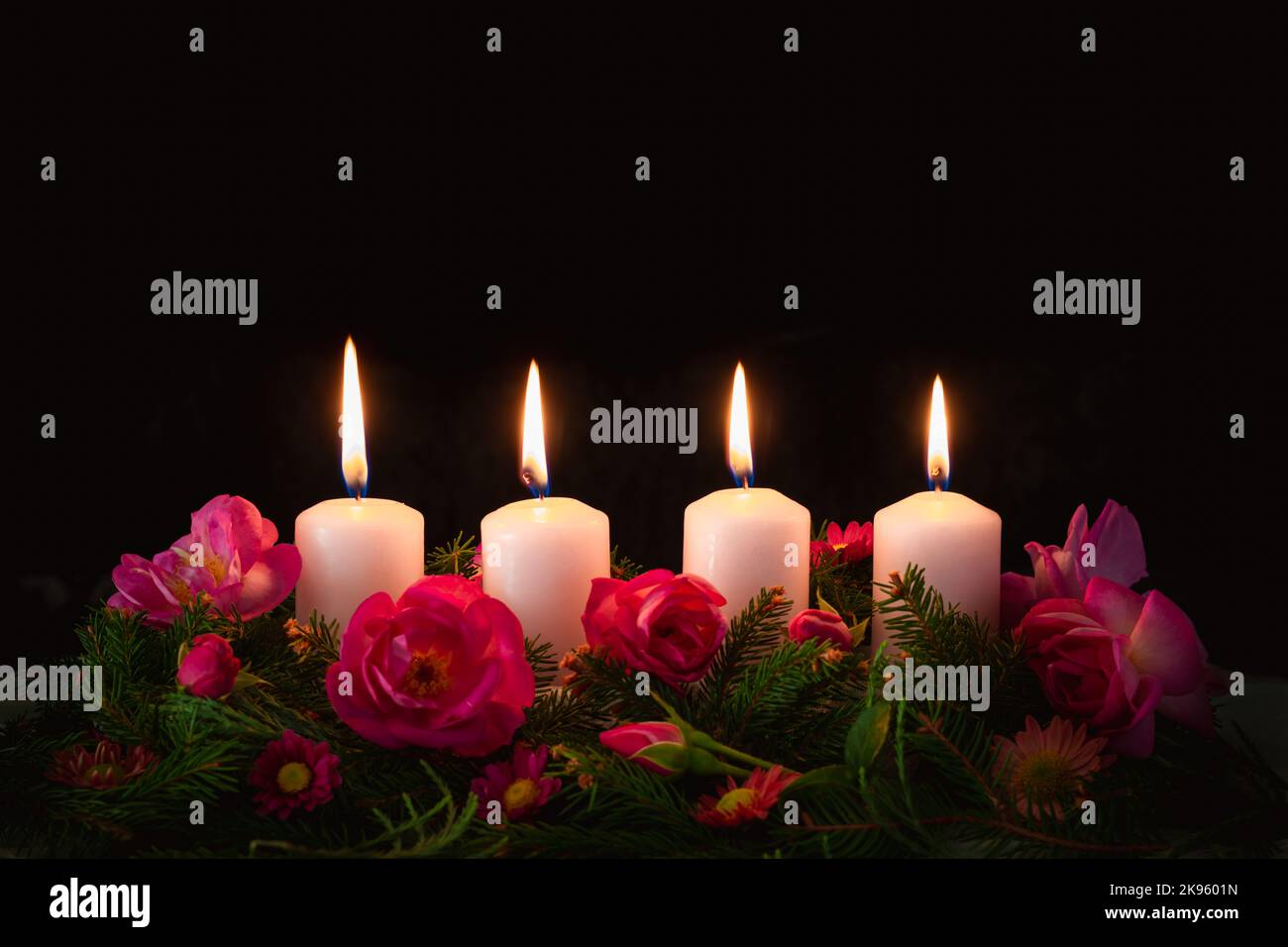 fourth burning advent candle on decorated rose flower pink advent ...