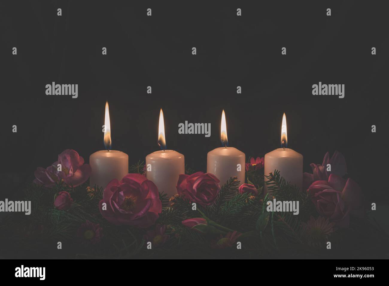fourth burning advent candle on decorated rose flower pink advent ...