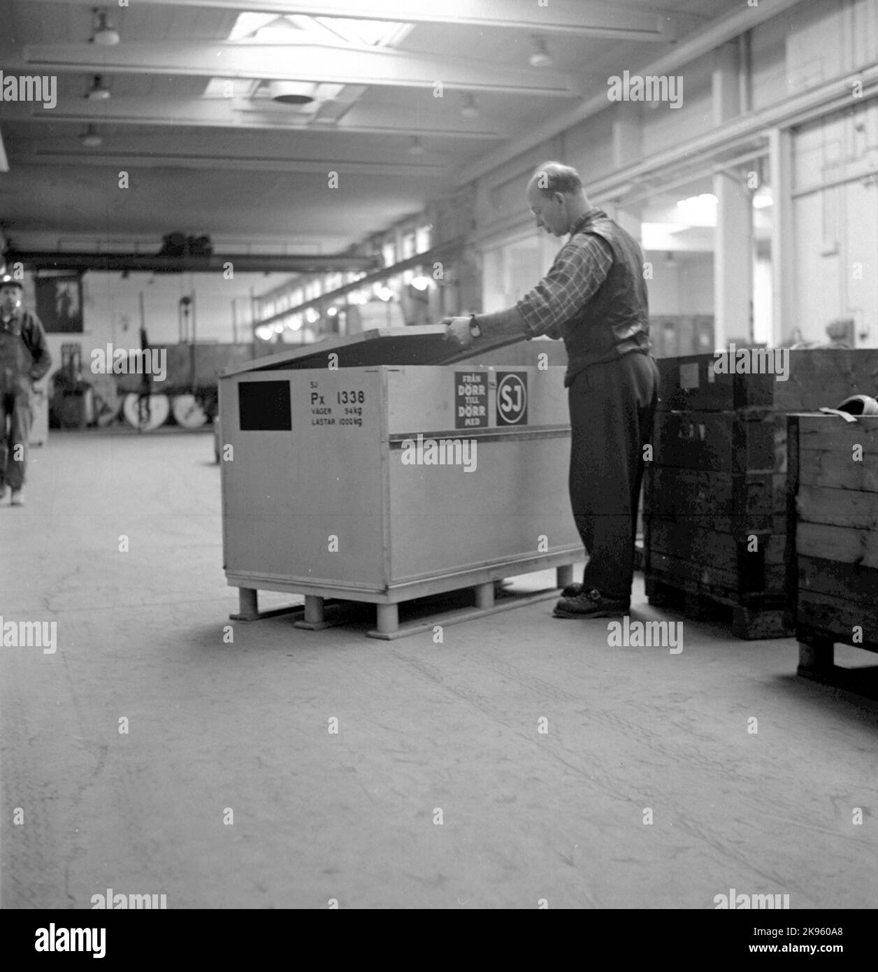Packing of small containers, Liljeholmens cable plant Stock Photo - Alamy