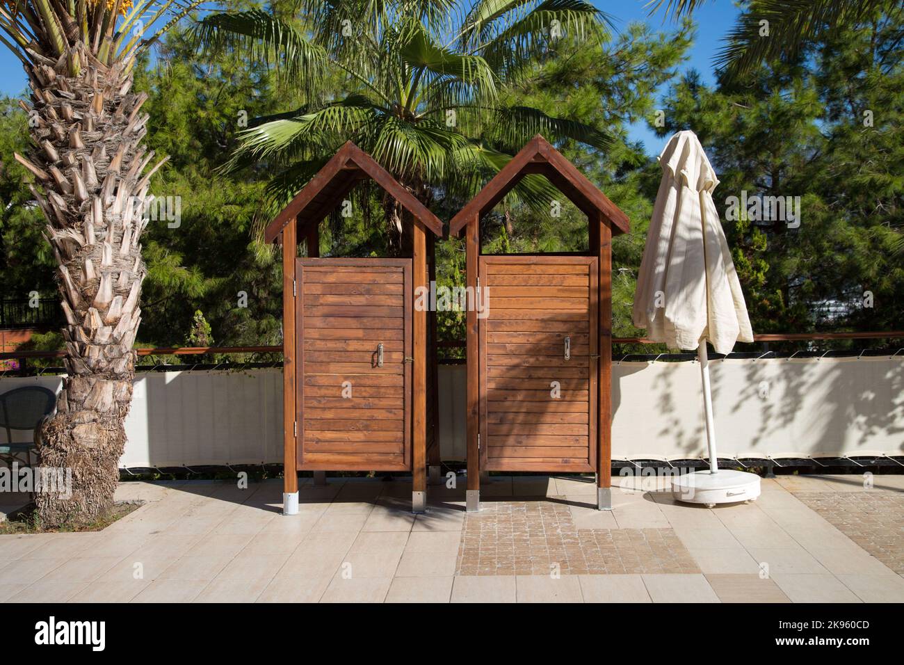 Two wooden changing booths near the pool hotel Stock Photo - Alamy