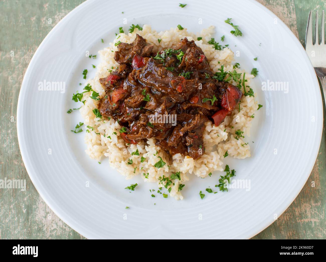 Beef ragout with brown rice on a plate. Cooked with low fat and high ...