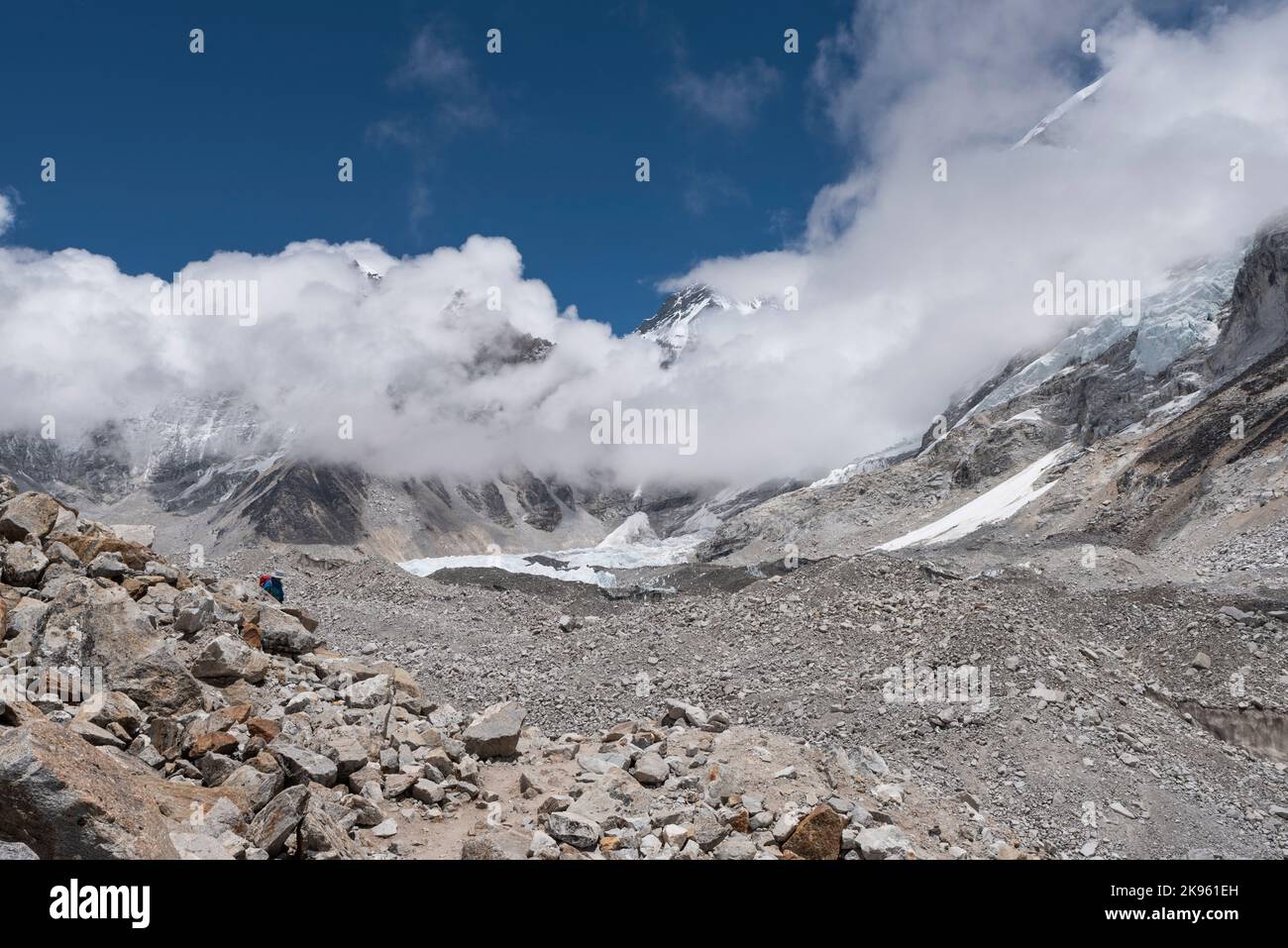 The peaks of Mount Everest covered with thick clouds under a blue clear ...