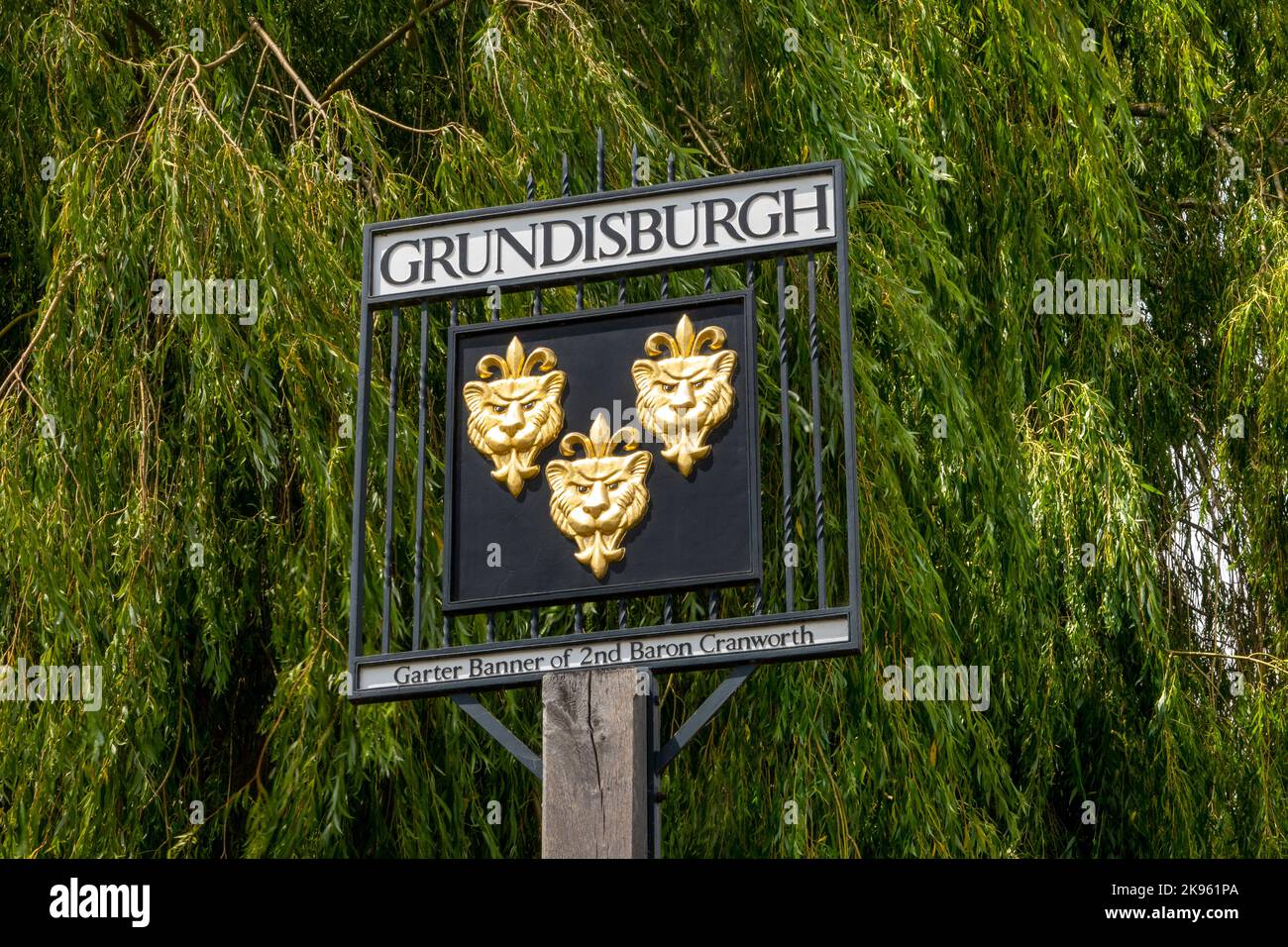 Grundisburgh village sign against a willow tree background Stock Photo ...