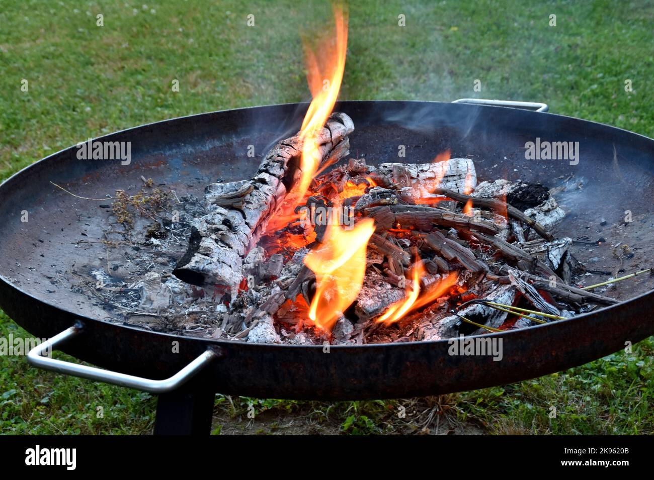 A glowing fire on disc grill Stock Photo - Alamy