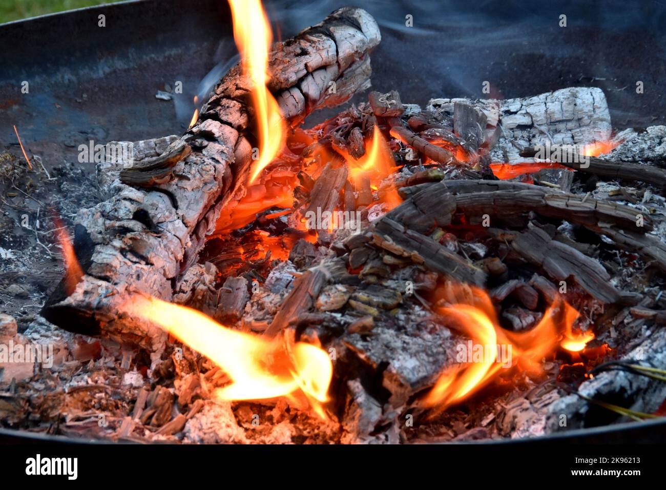 A glowing fire on disc grill Stock Photo - Alamy