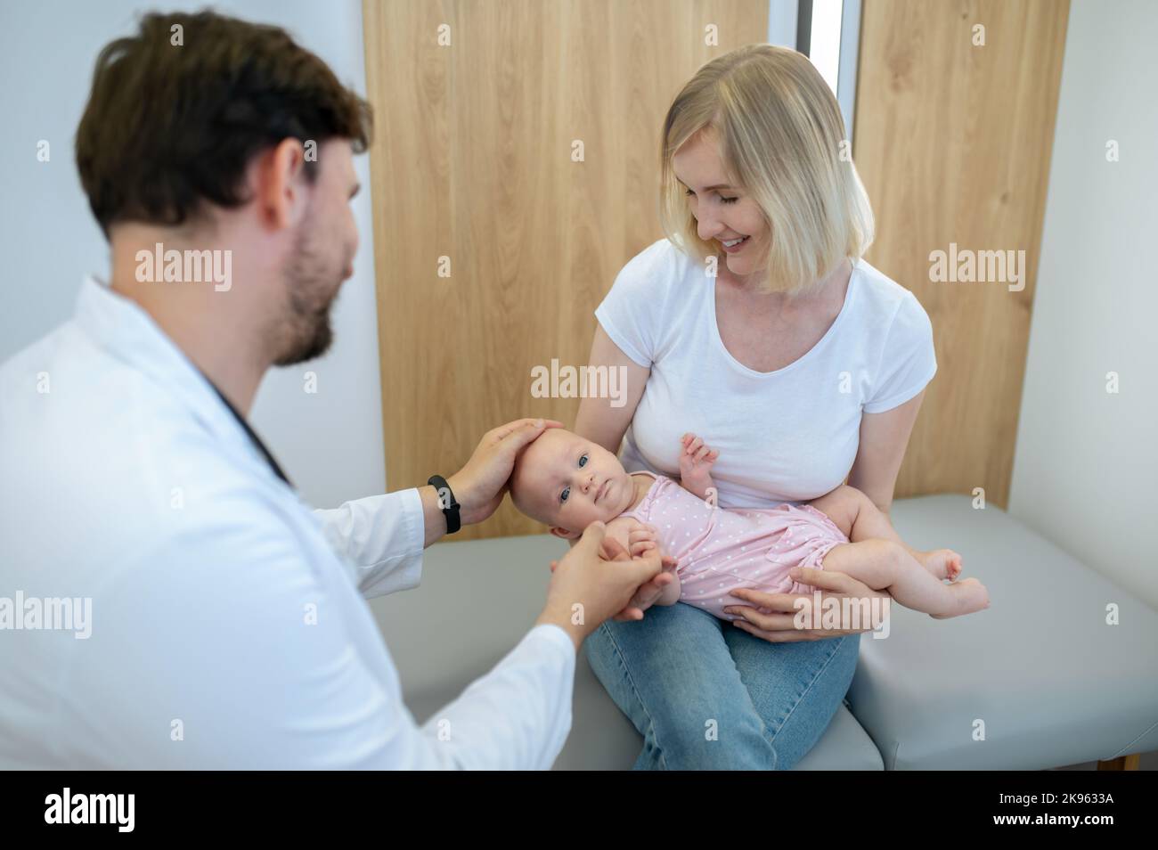 Pediatric doctor examining a cute newborn baby Stock Photo - Alamy