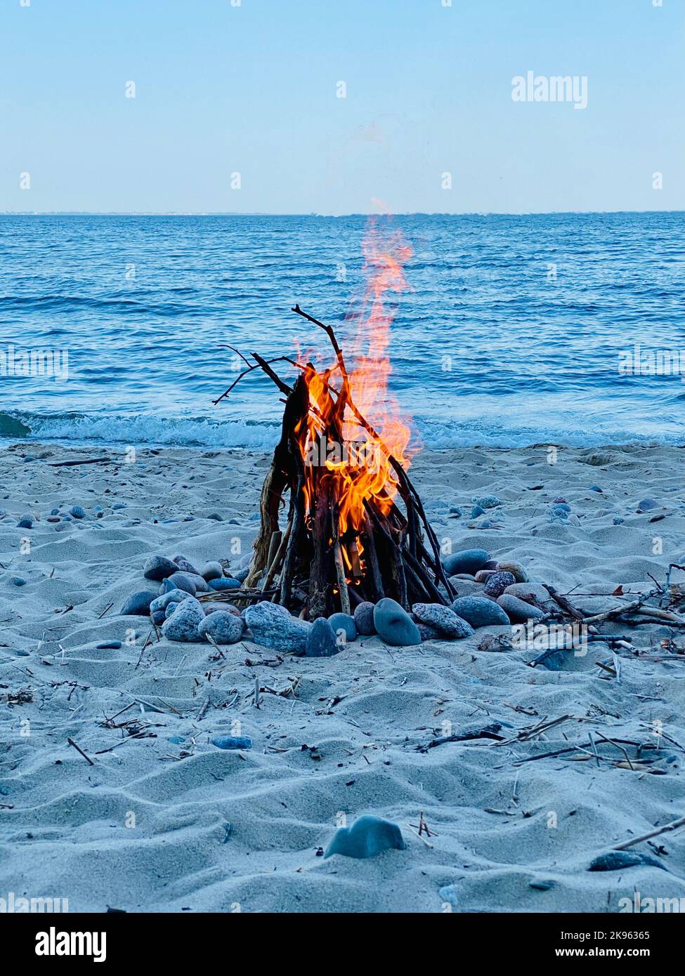 A glowing fire in beach in background of sea Stock Photo - Alamy