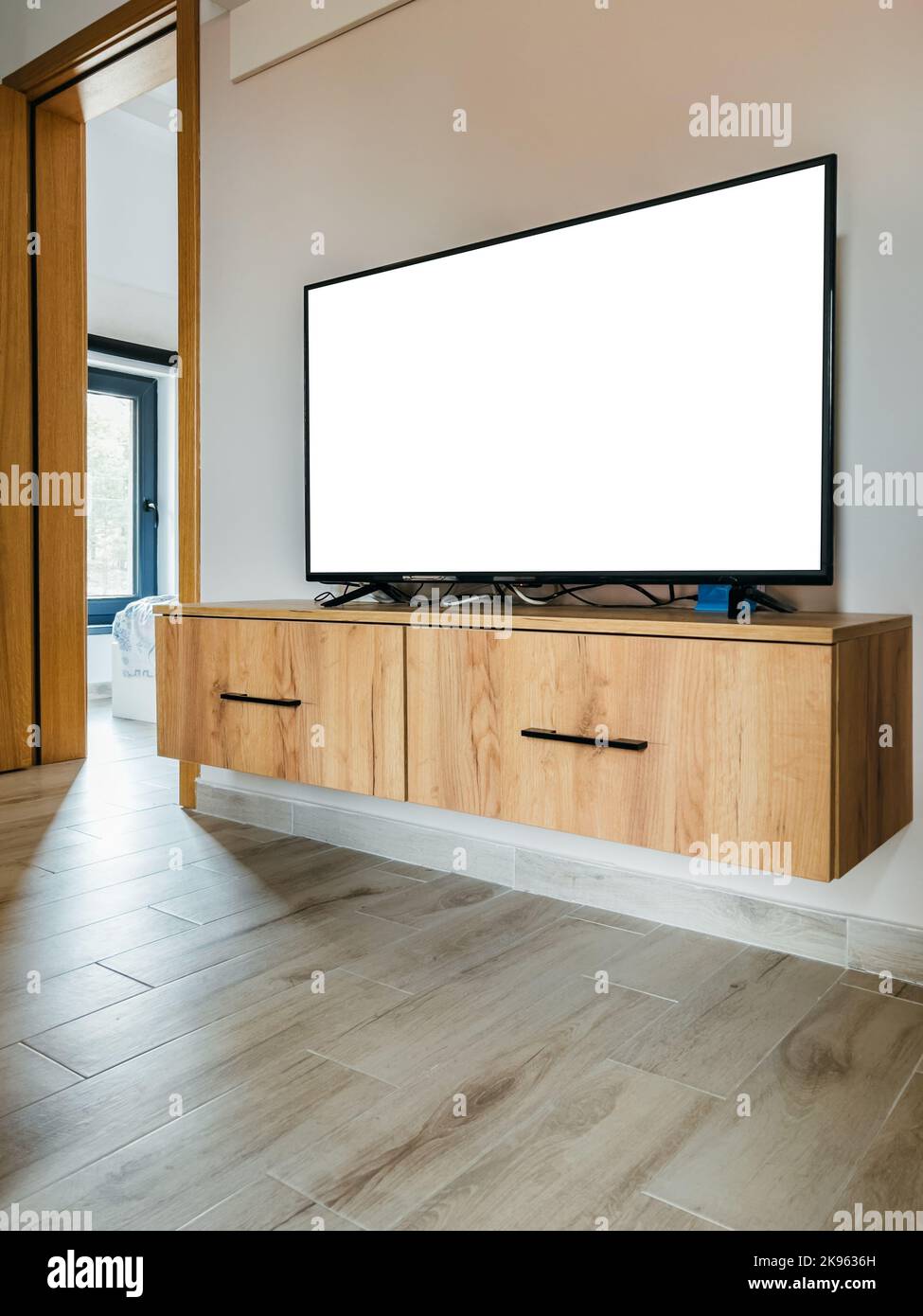 A vertical shot of a TV with a white screen on a wooden counter Stock ...