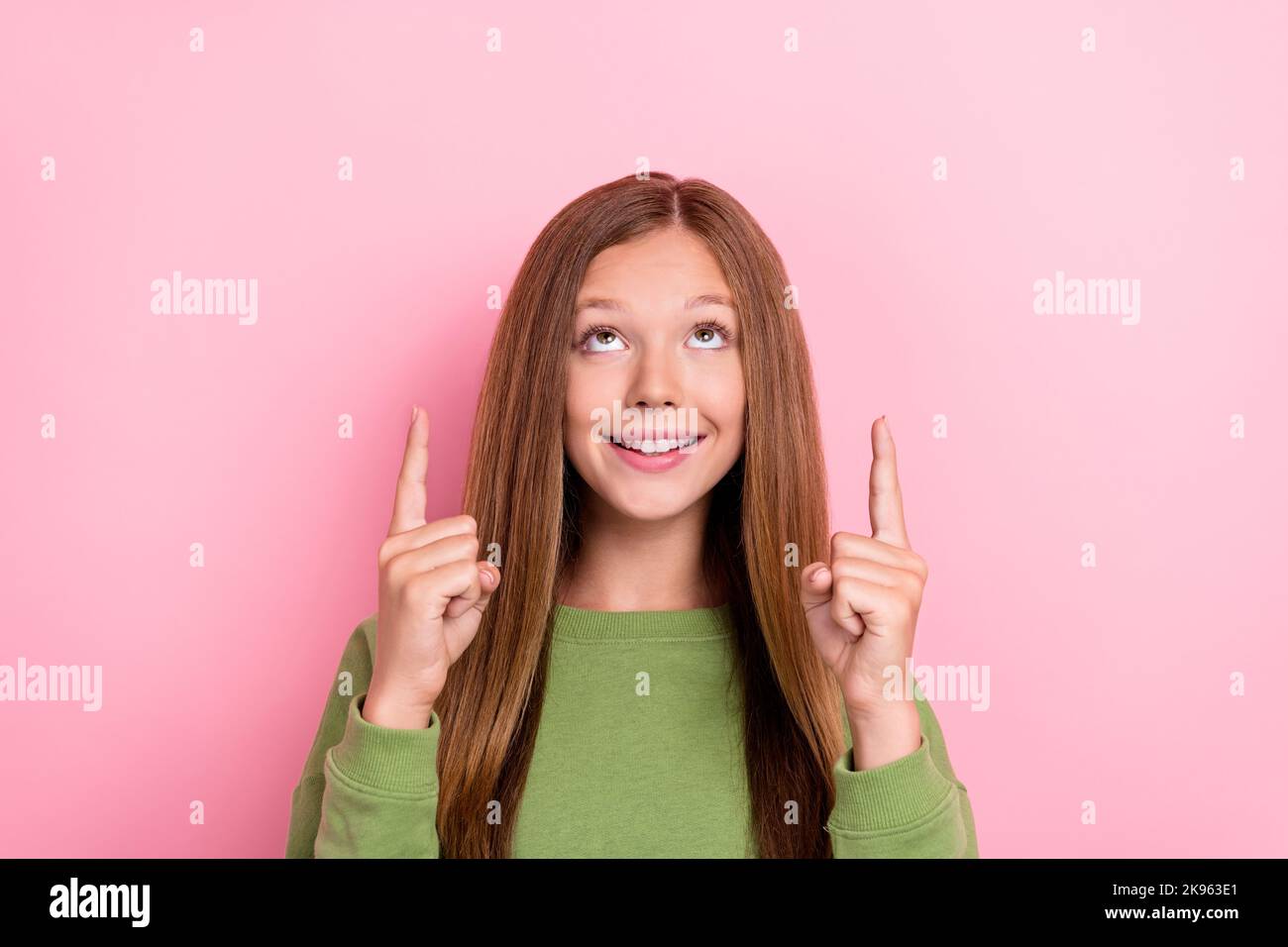 Portrait of nice optimistic girl with long hairdo dressed green ...