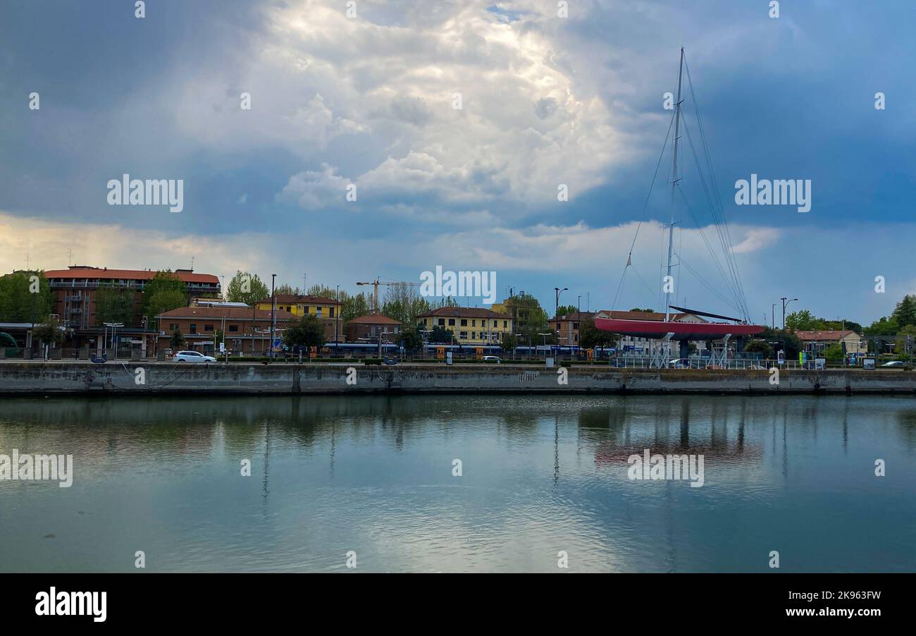 An aerial view of dock surrounded by buildings with reflection in water ...