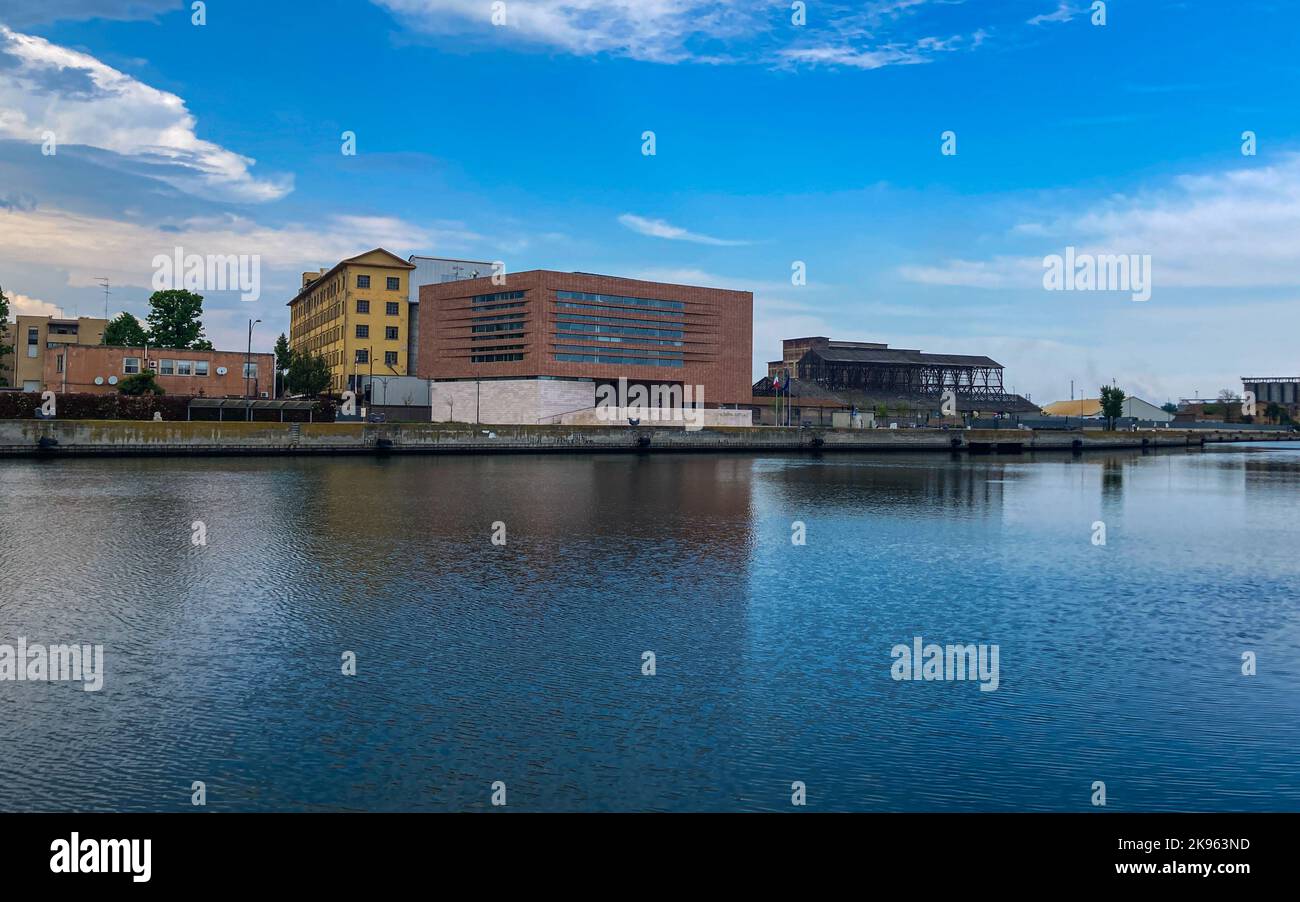 An aerial view of dock surrounded by buildings with reflection in water ...