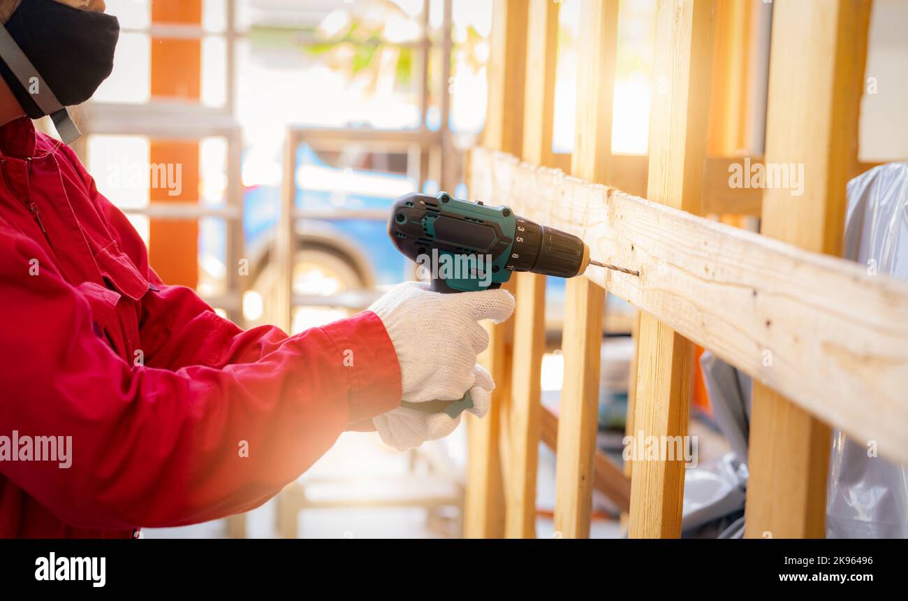 Technician use cordless drill drilling wooden box. Heavy machinery ...