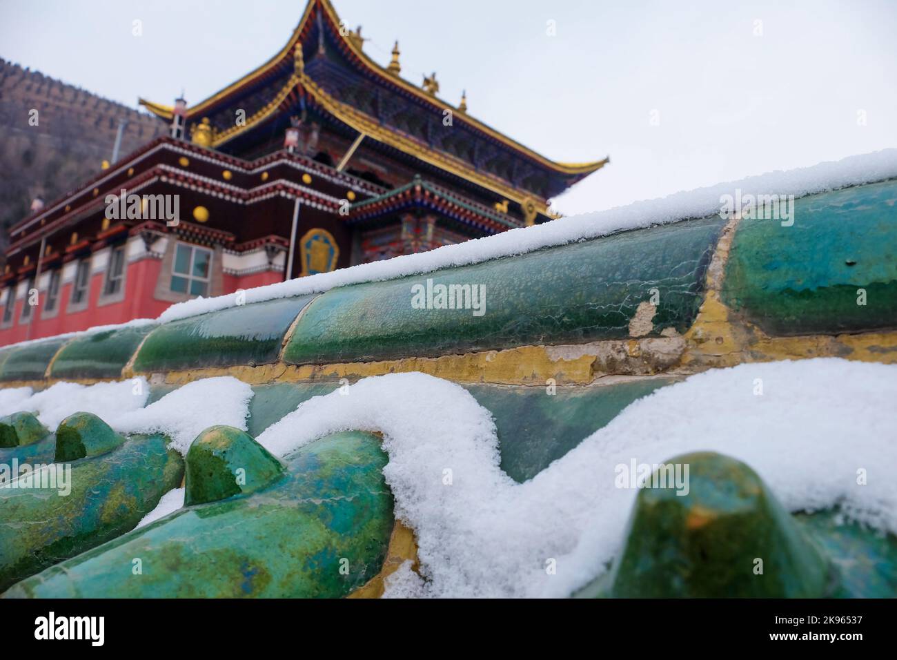 A closeup of the green glazed roof tails covered in snow in Ta'er ...