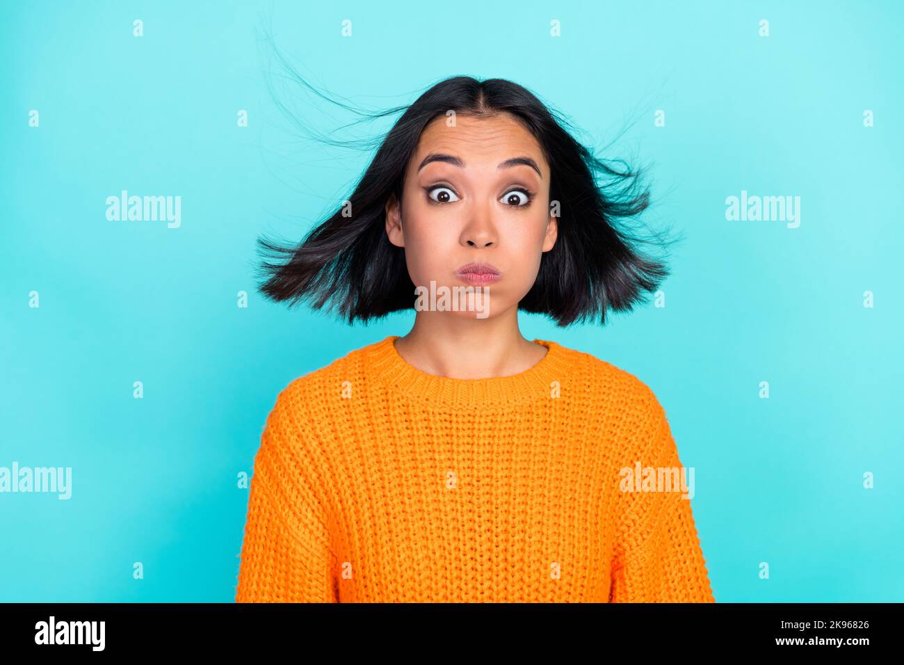 Photo of shiny shocked young lady wear orange sweater wind blowing ...