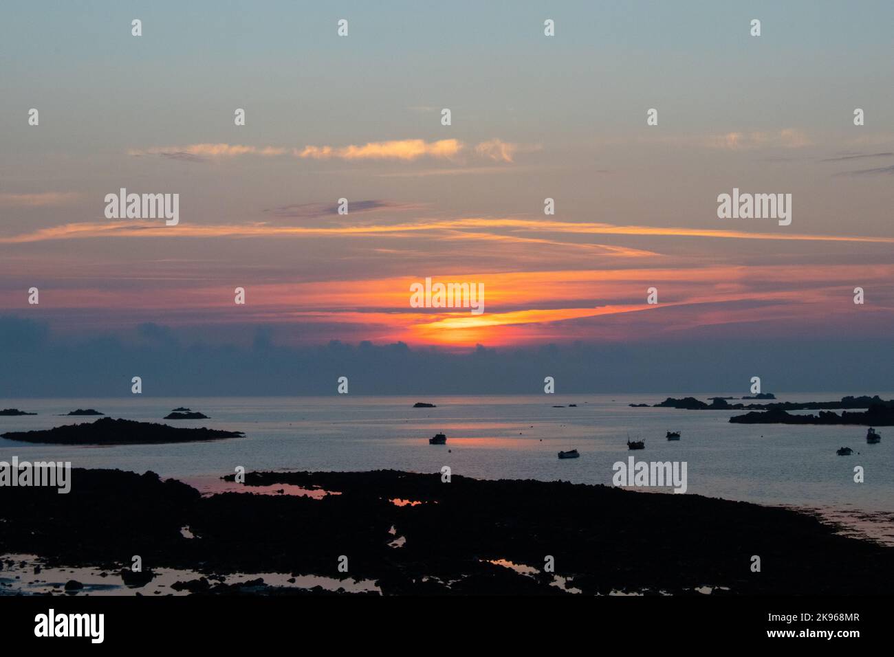 The sunset over Cobo Bay on the west coast of Guernsey Stock Photo - Alamy