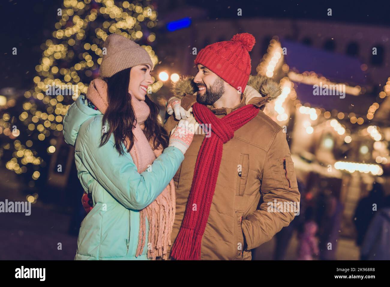 Photo of sweet young couple walk hug wear cap jacket scarf gloves at ...