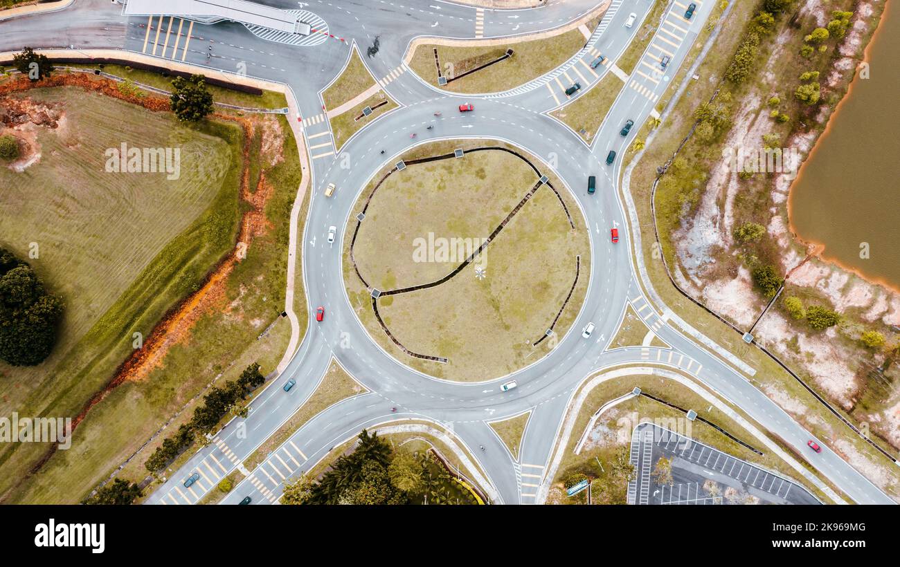 Aerial top down view of traffic roundabout on a main road. Aerial view of roundabout in the city ...
