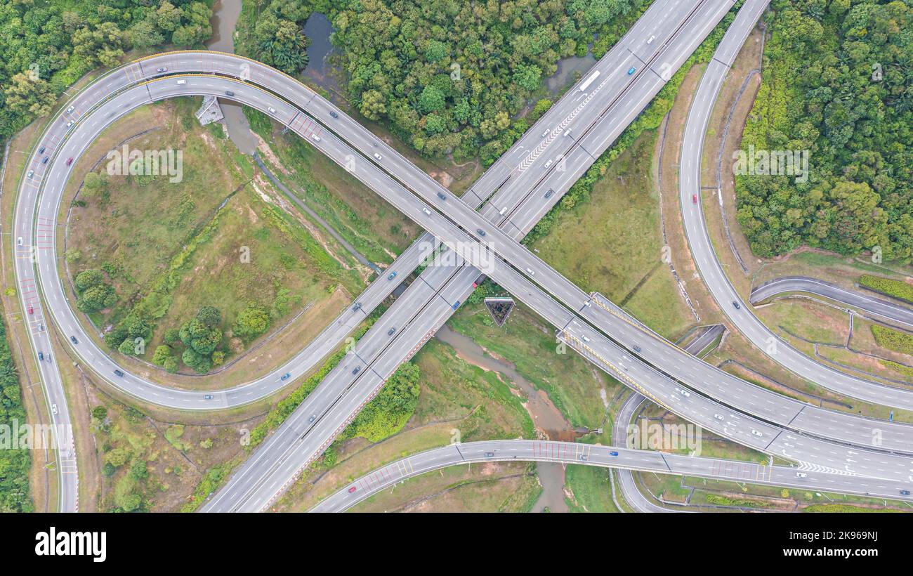 Aerial view of highway and overpass in city on a sunny day. Road ...