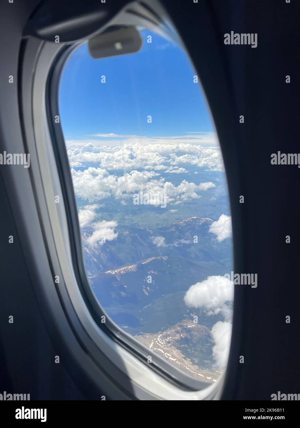 A vertical shot from an airplane window of a landscape of rough ...