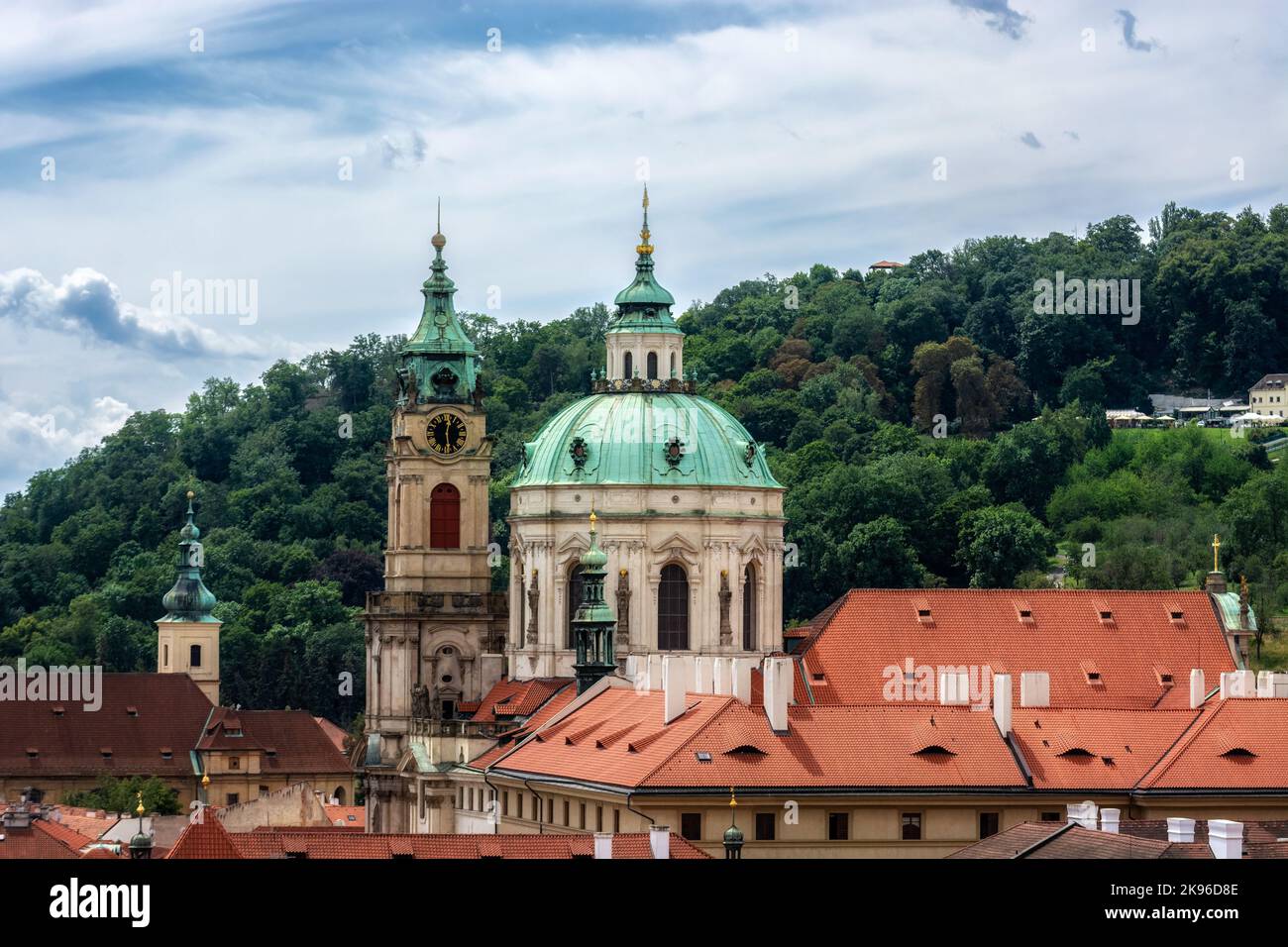 Towers with green domes of the Church of St. Nicholas in the Czech city ...