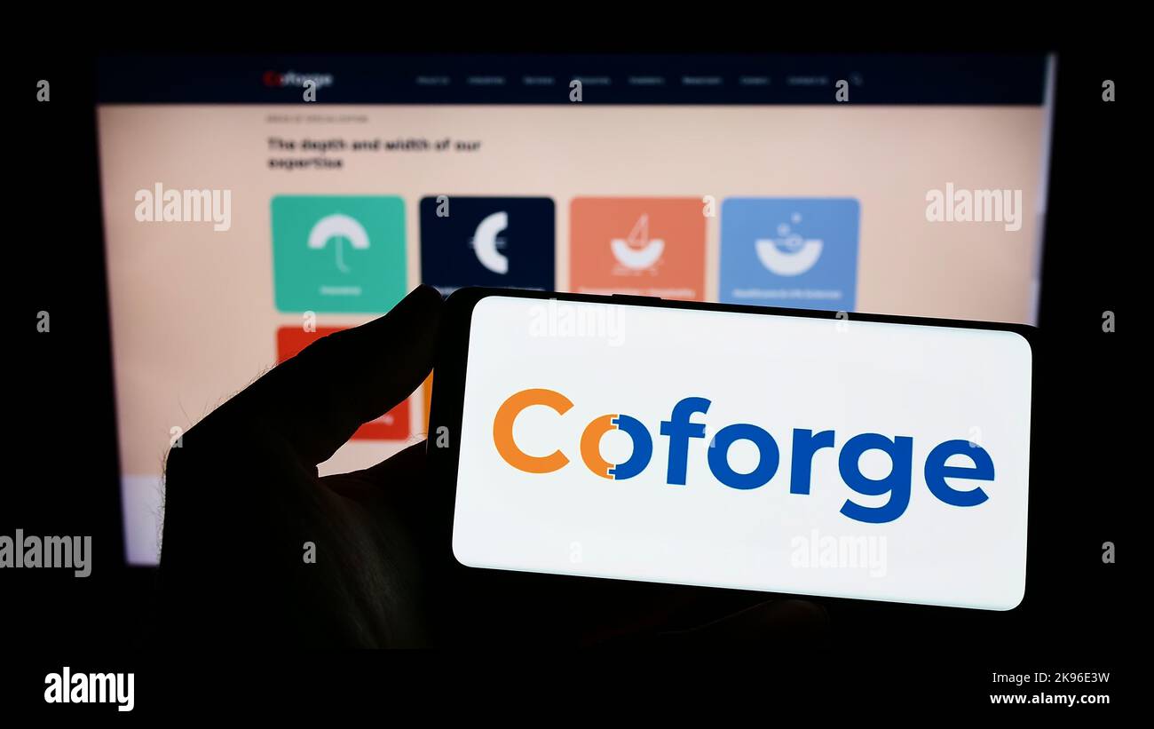 Person holding cellphone with logo of Indian information technology ...